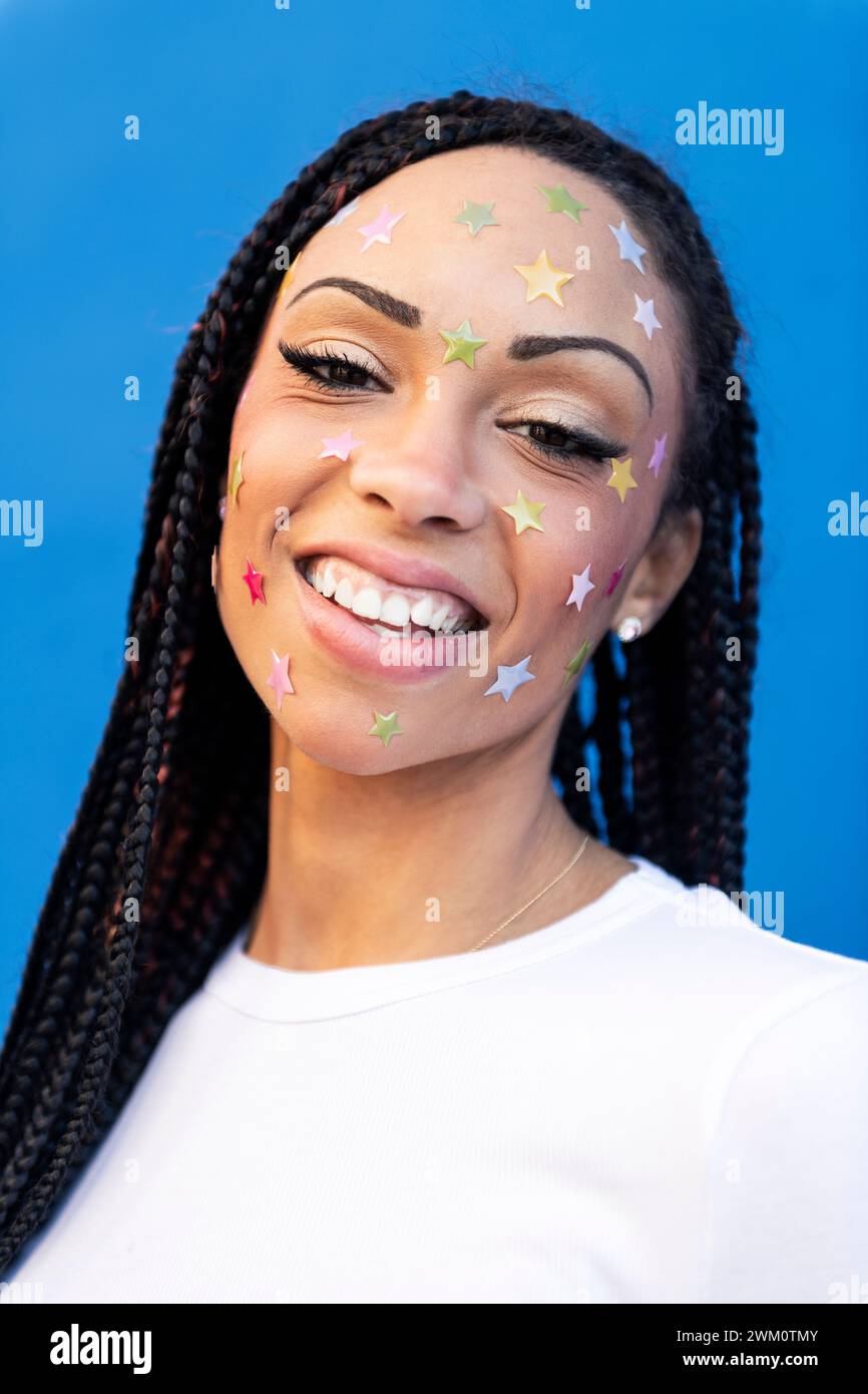 Smiling face over blue hi-res stock photography and images - Alamy