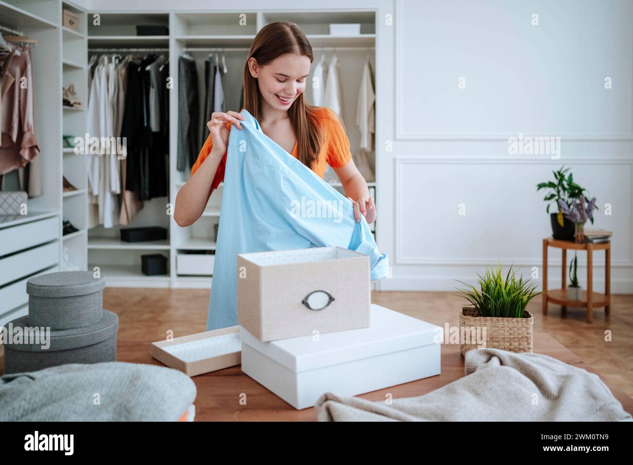 Woman folding cardboard boxes hi-res stock photography and images - Alamy