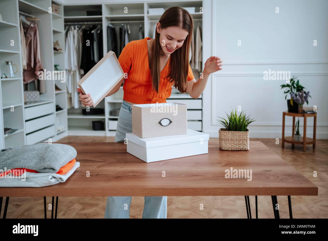 Young happy woman opening present hi-res stock photography and images ...