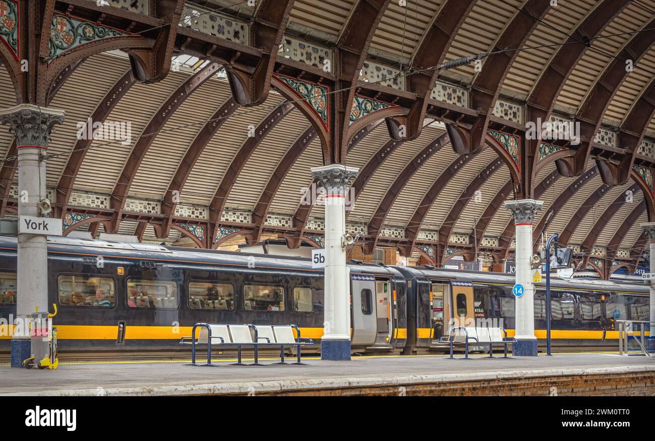 Carriages of a railway train is beside a platform preparing to depart ...