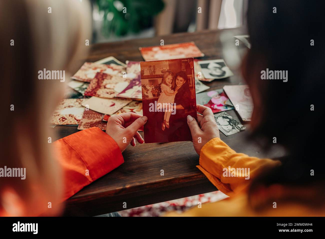Mother and daughter looking at family photos Stock Photo - Alamy