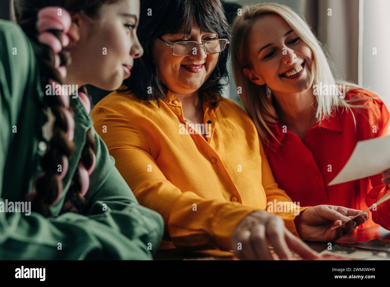 Happy family looking at photographs Stock Photo - Alamy