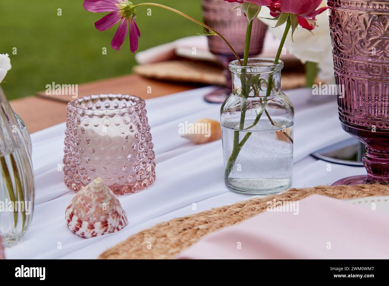 Picnic aesthetics table setting, flowers arrangement, shells close up ...