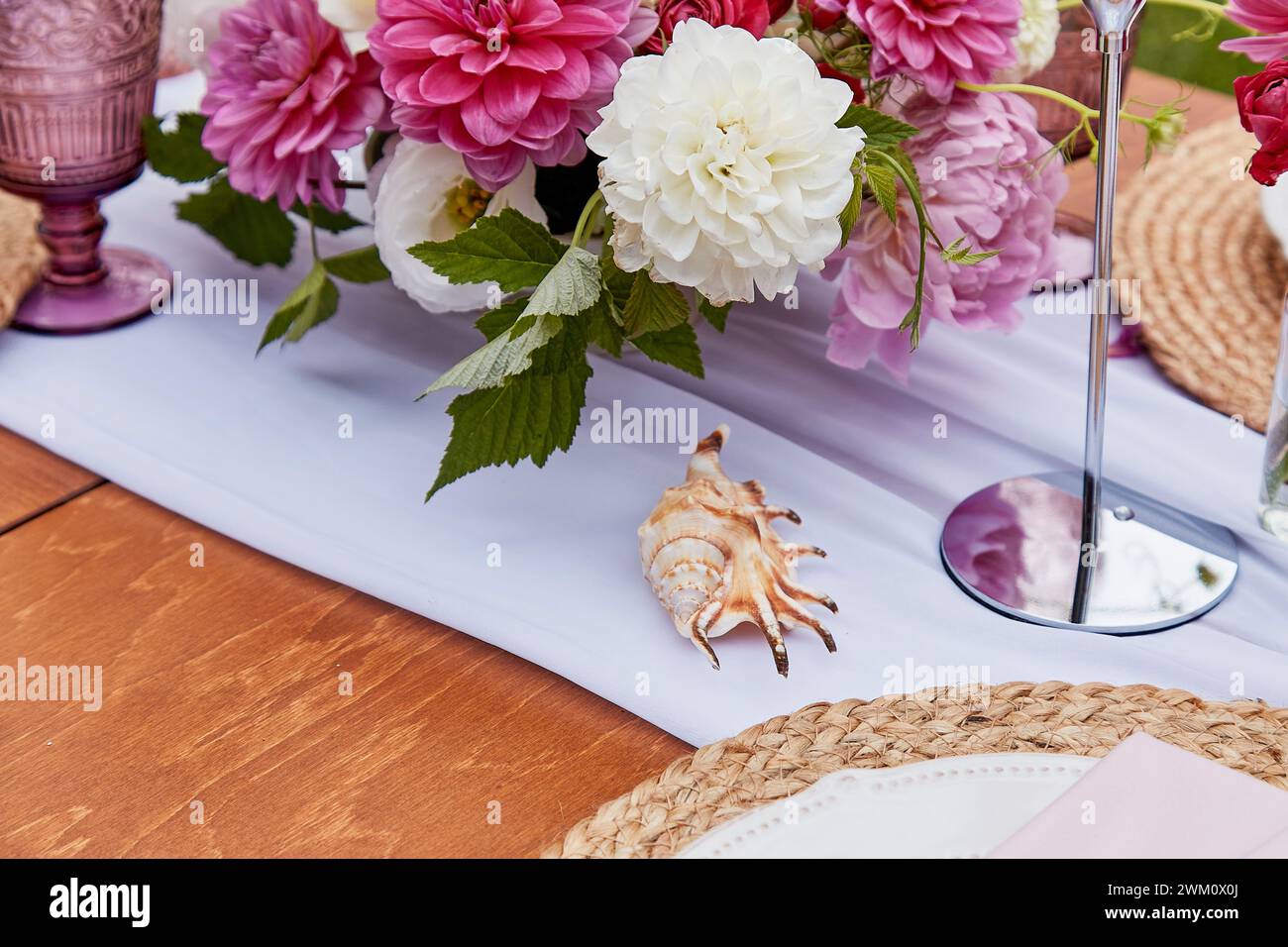 Stylish table setting with shell, pink girly flowers arrangement Stock ...