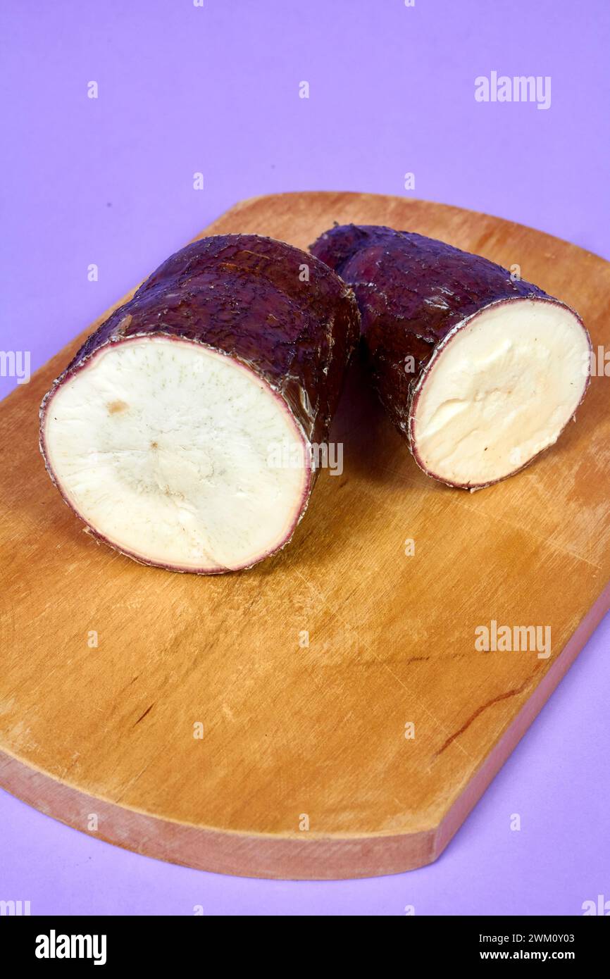 Fresh Organic Cassava Root, Manioc Esculenta, yuca On purple Background ...