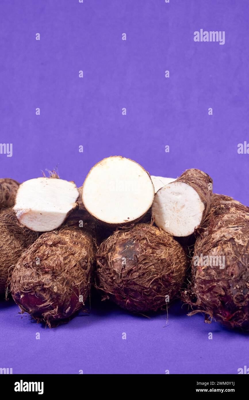 closeup of taro root vegetable, eddo malanga, purple background Stock ...