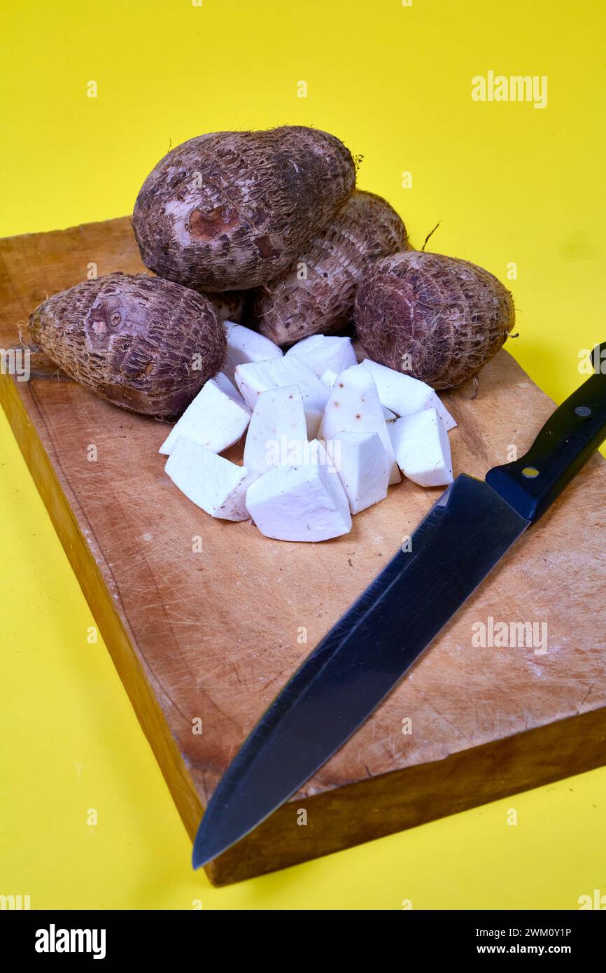 closeup of taro root vegetable, eddo malanga, yellow background Stock ...