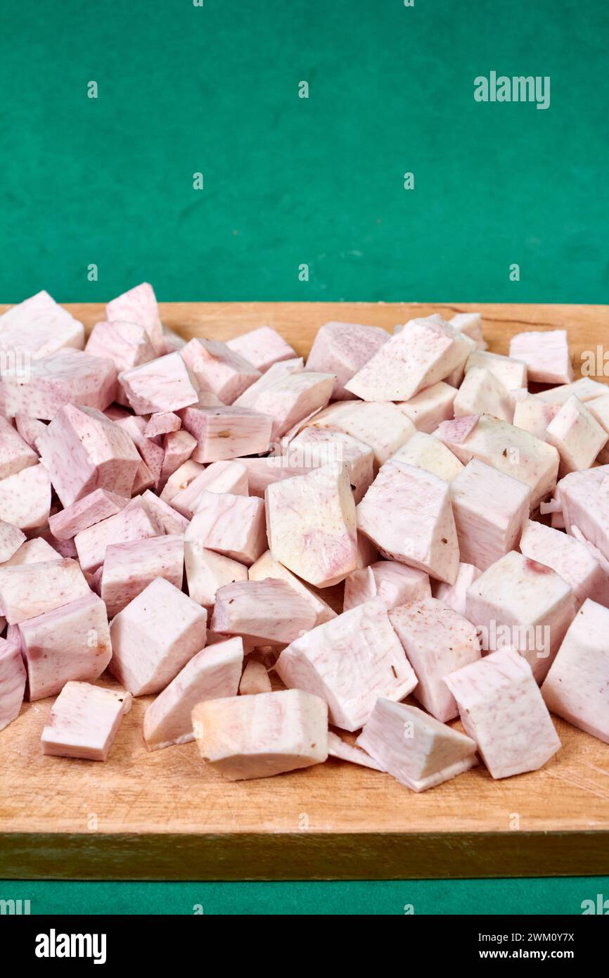 closeup of taro root vegetable, eddo malanga, green background Stock ...