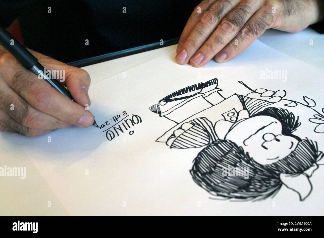 3823460 Quino drawing his character Mafalda; (add.info.: Milan, October ...