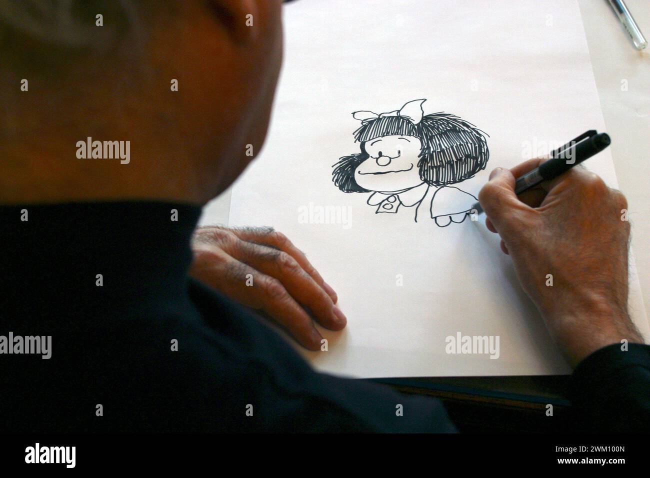3823457 Quino drawing his character Mafalda; (add.info.: Milan, October ...
