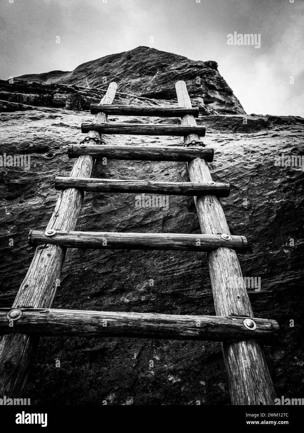 Rustic wooden ladder up a rock face Stock Photo - Alamy