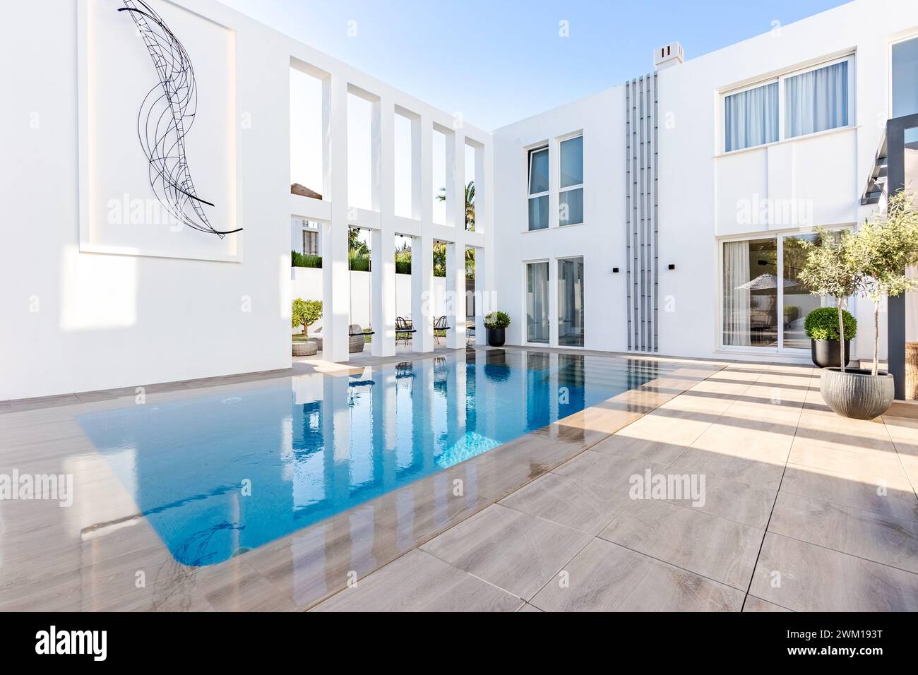 a luxury infinity swimming pool in the back yard of a luxury ...
