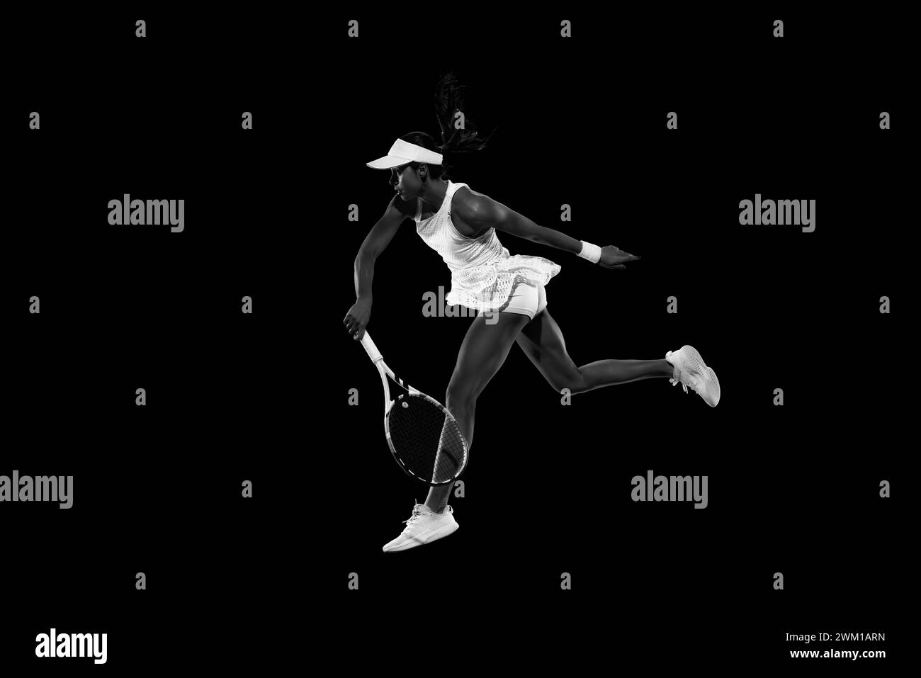 Dynamic photo of tennis player leaping to hit overhead shot in match ...