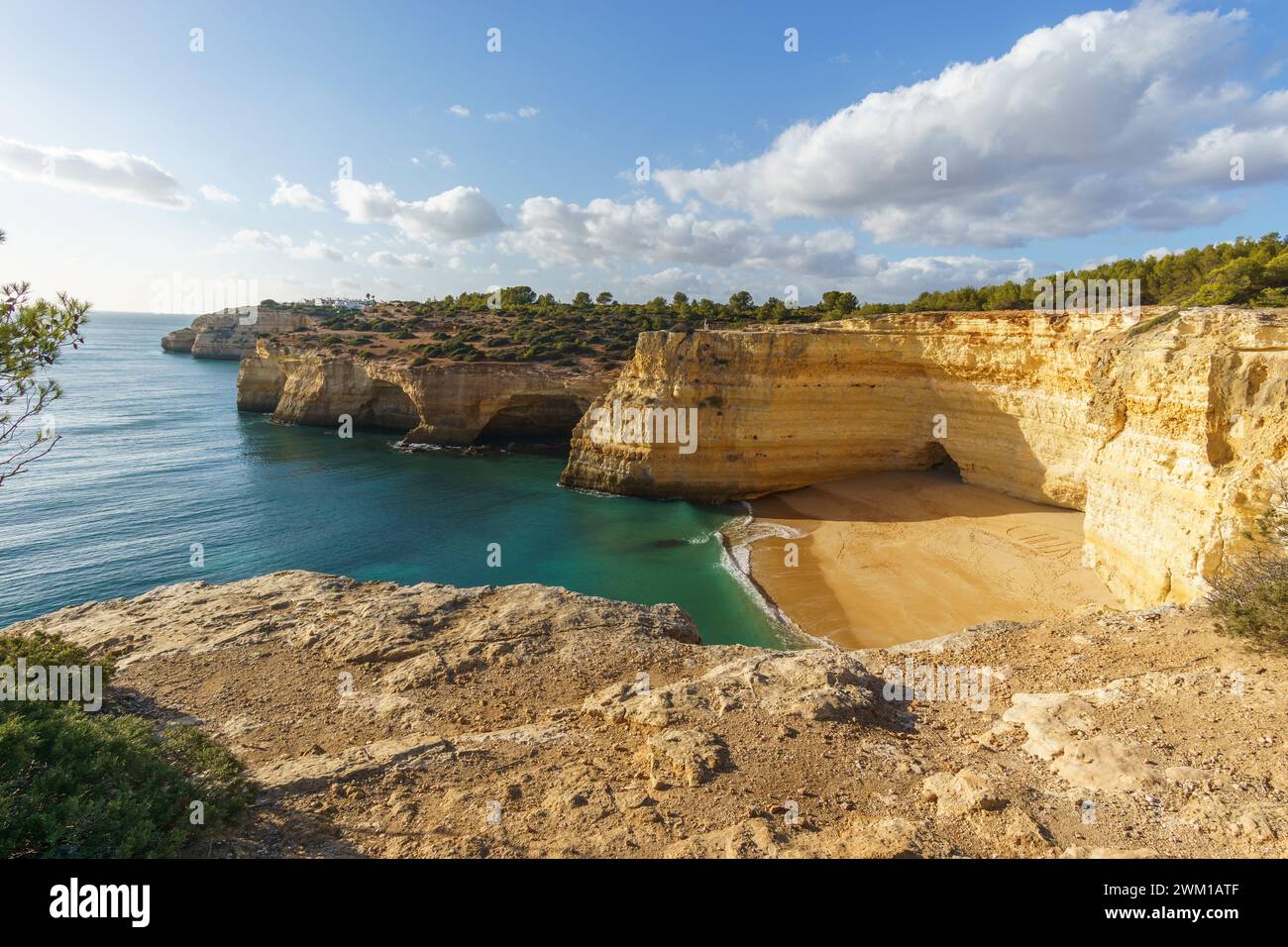 Golden rock cliffs at the coastline of the Atlantic Ocean with beach ...