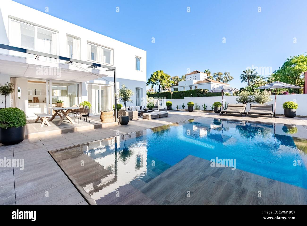 a luxurious mediterranean mansion garden with various seats and ...