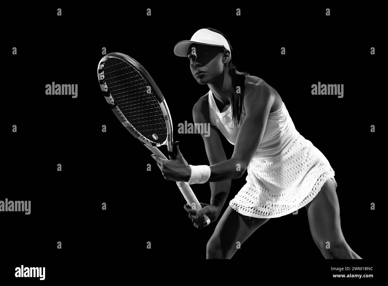 Focused athlete in tennis attire awaiting opponent's serve against ...