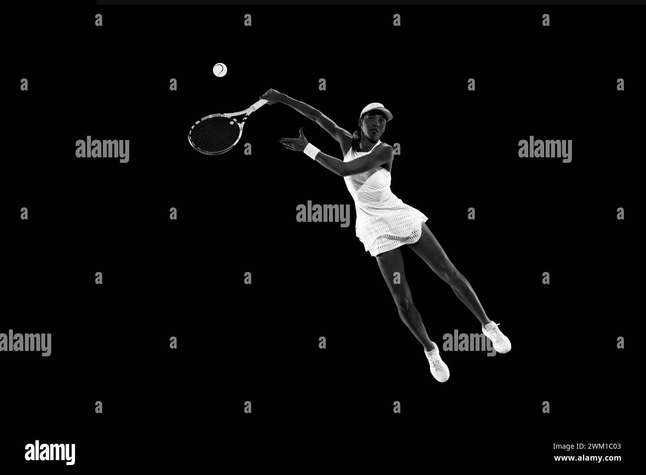 Dynamic photo of tennis player leaping to hit overhead shot in match ...
