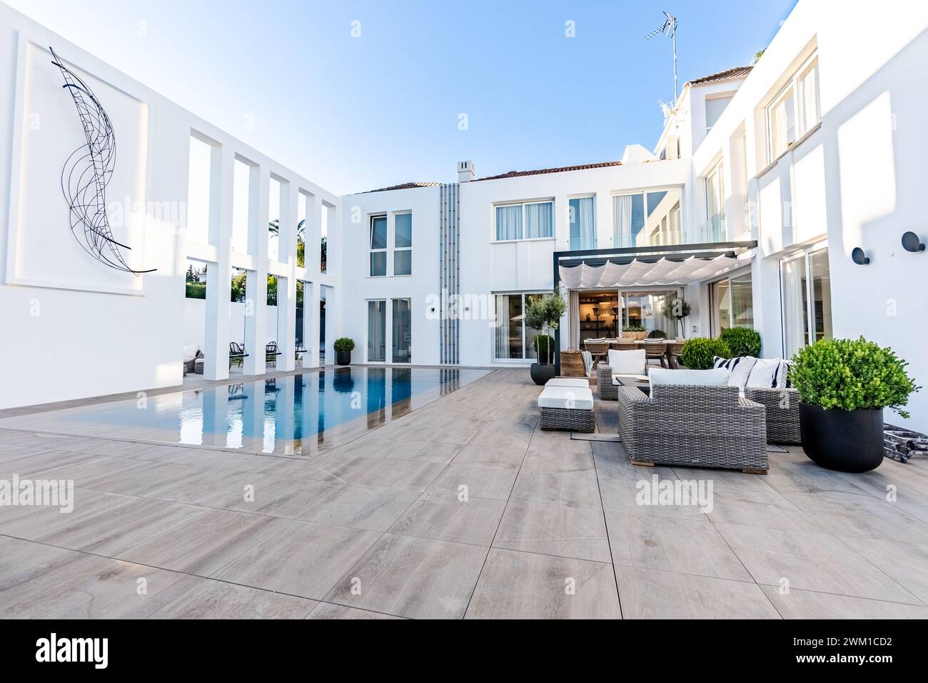 a luxurious mediterranean mansion garden with various seats and ...