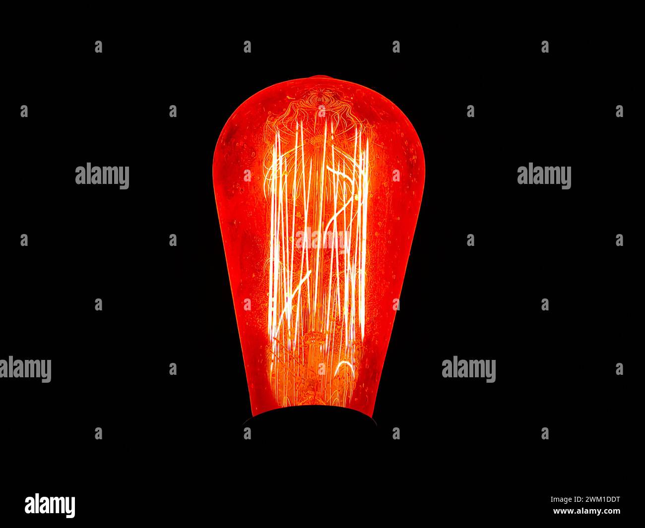 Luminous Contrast. Neon Light Bulb Fixture in the Dark. Red flame ...