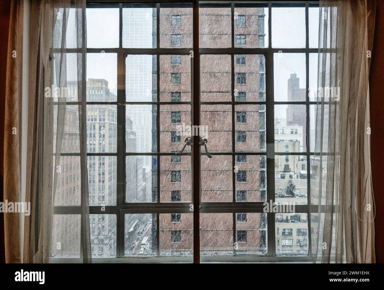 Snowfall through a casement window in an apartment in Murray Hill, 2024 ...