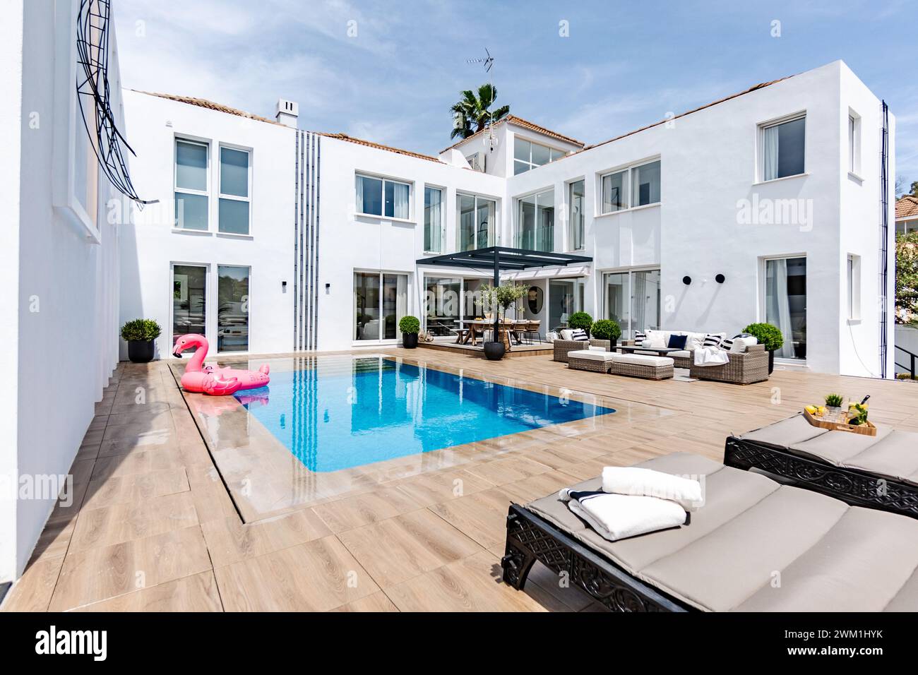 a luxury mediterranean mansion with beautiful garden furniture and an ...