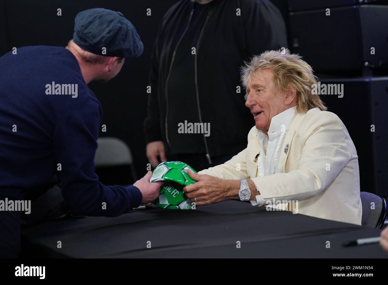 Rod Stewart signs a Celtic FC football during a signing session with ...
