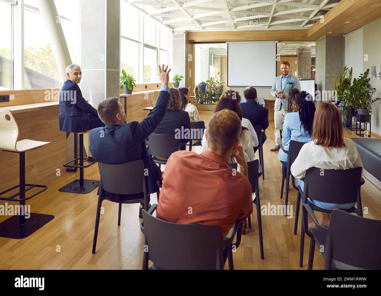 Group of company employees or a team of staff sitting on chairs on ...