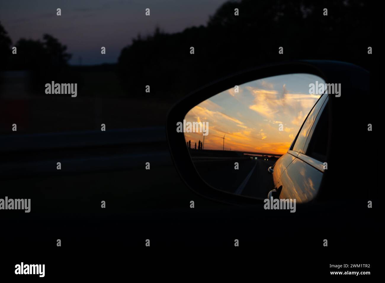 View in the outside rearview mirror of a car. View from inside of the ...