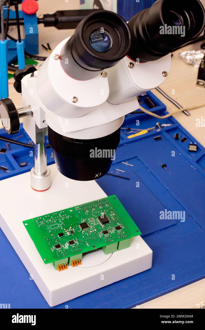 Soldering process on a green PCB close up Stock Photo - Alamy