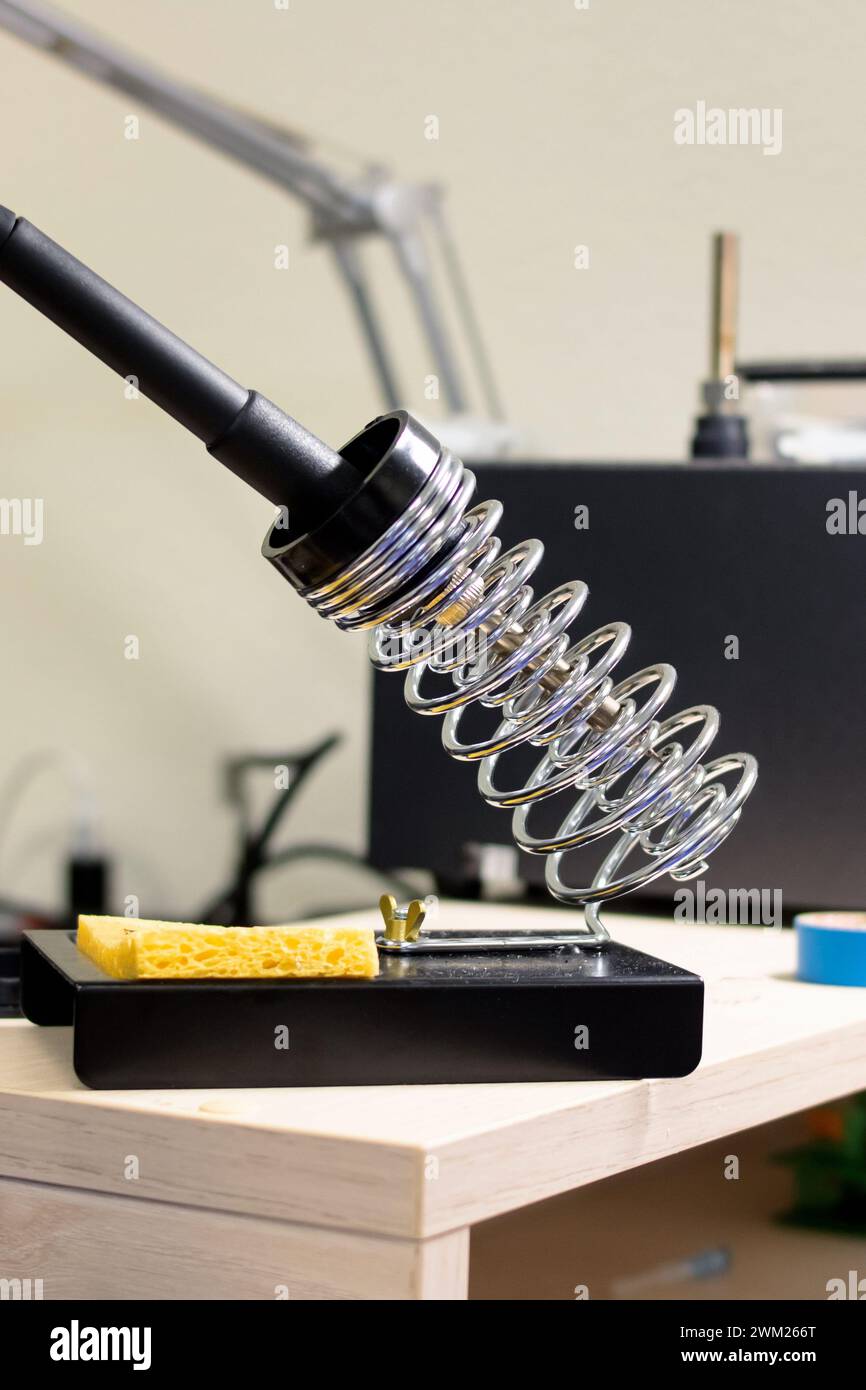 Soldering iron in a metal stand close up Stock Photo - Alamy