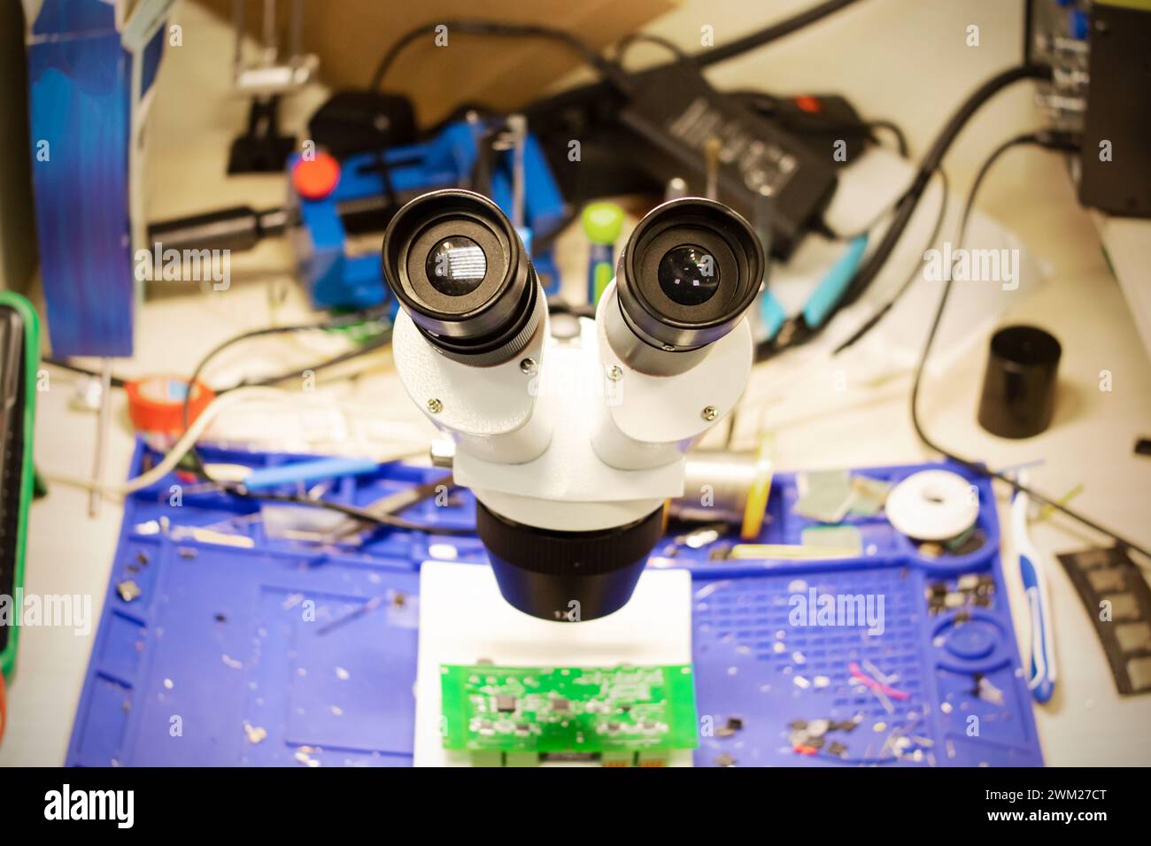 Modern engineering microscope over green board close up Stock Photo - Alamy