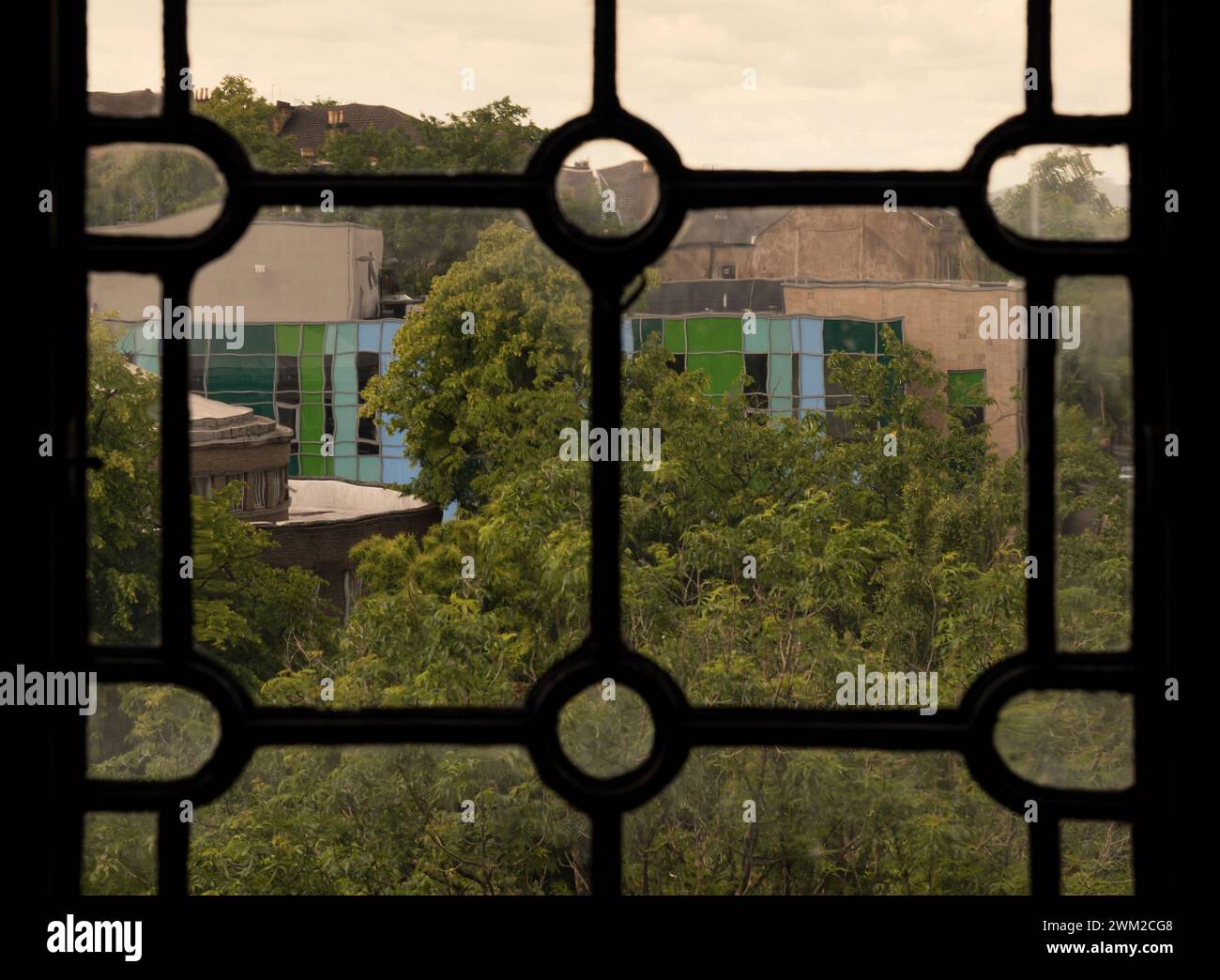 Ancient architectural window detail looking to modern windows of the ...