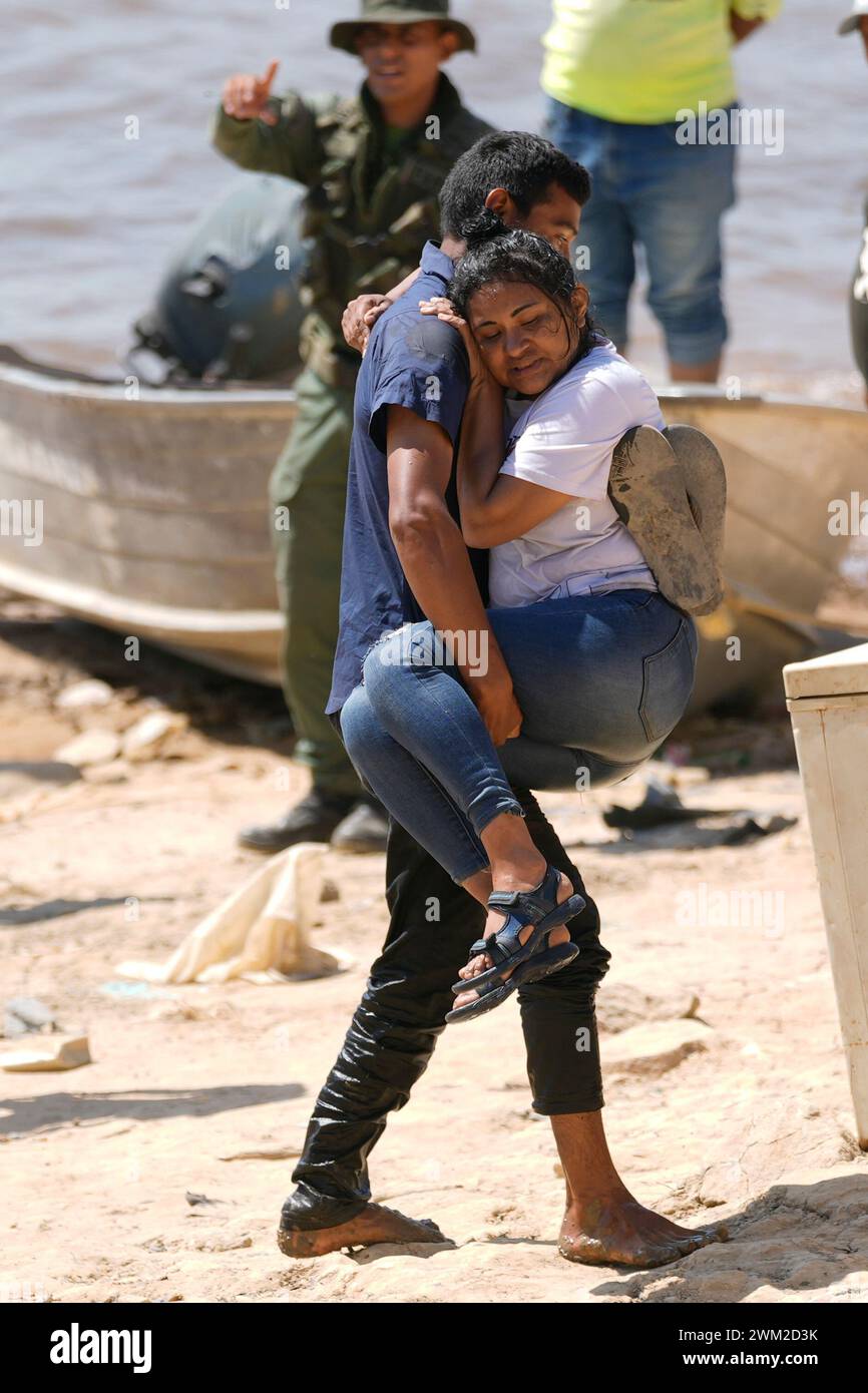 People arrive by boat after leaving La Bulla Loca mine, which collapsed ...