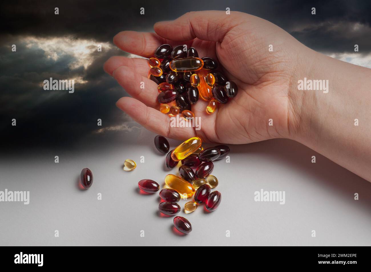 In the image, a hand is shown tightly holding a handful of multicolored ...