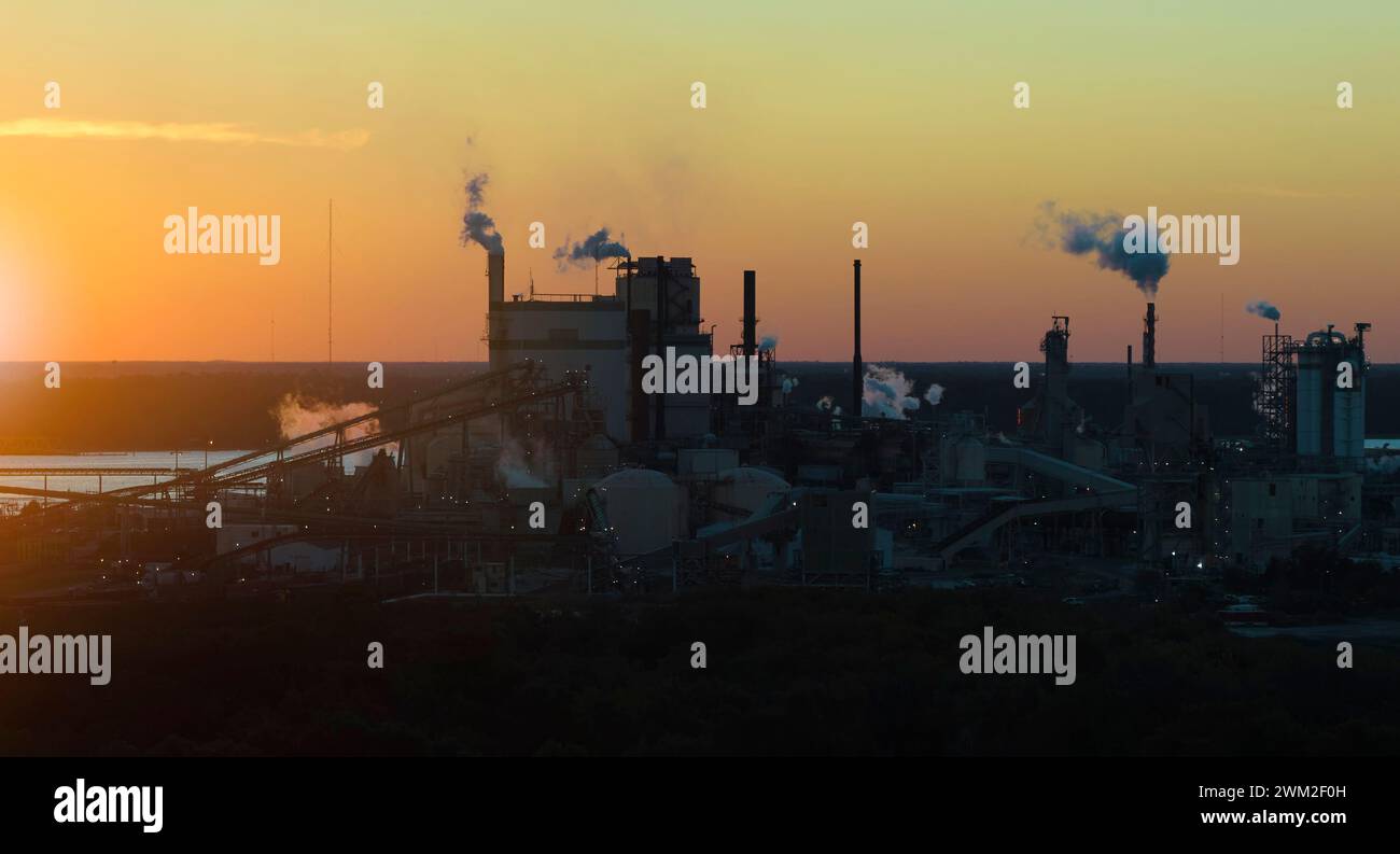 Aerial view of large factory with smokestack from production process ...