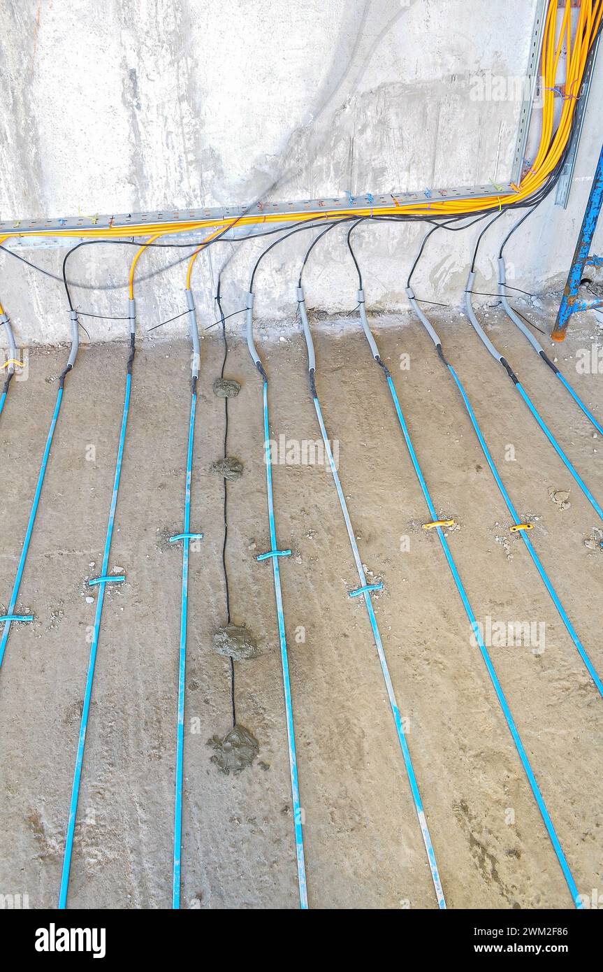Warm floor cable installation on concrete at a construction site Stock ...