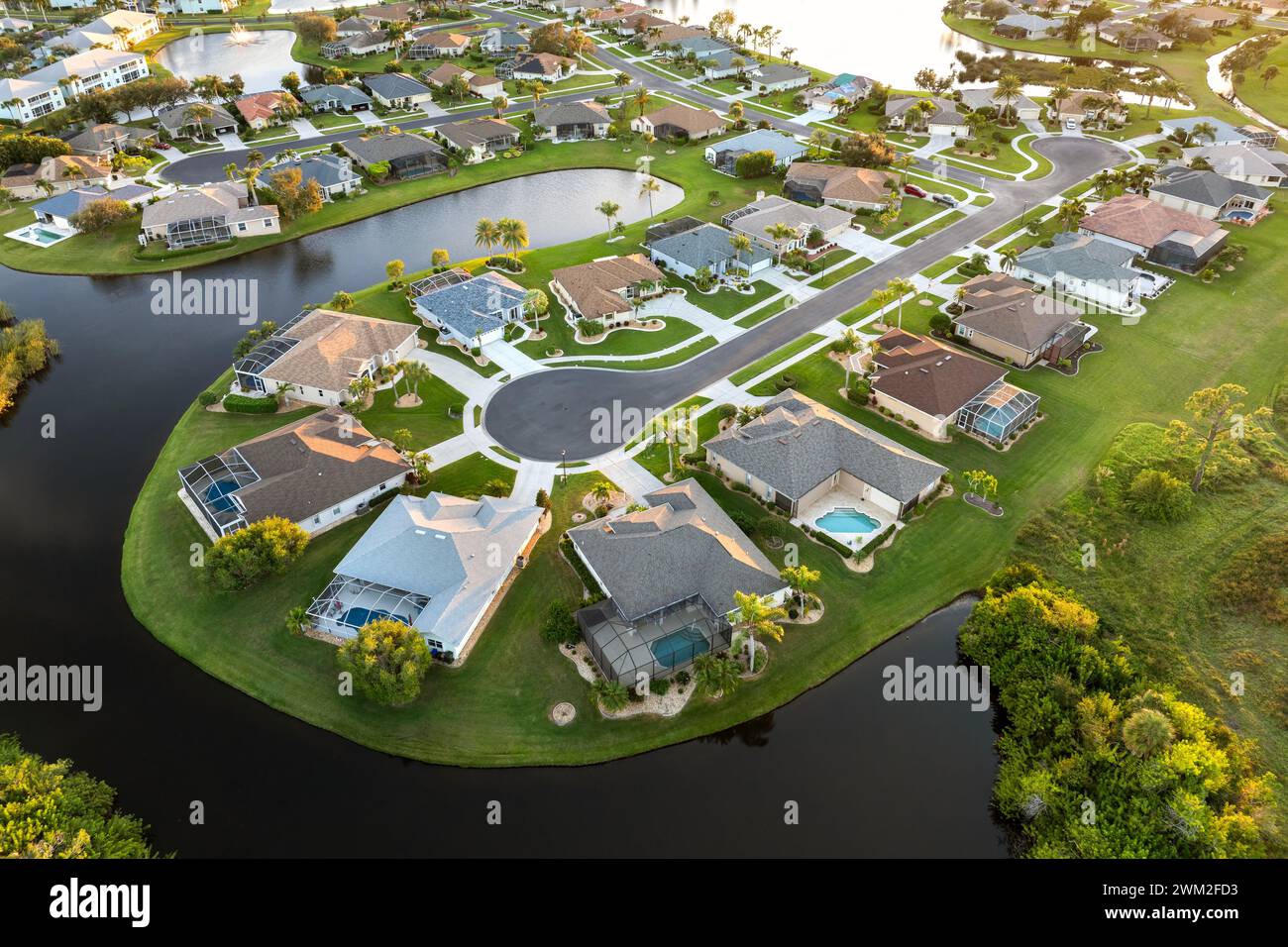 Aerial view of private homes in Florida residential area at sunset. New ...