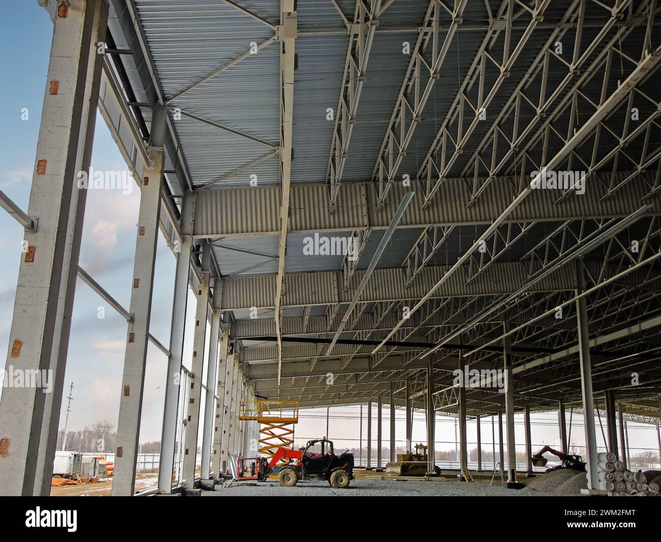 Warehouse with high columns, metal rafter structures. Construction of a ...