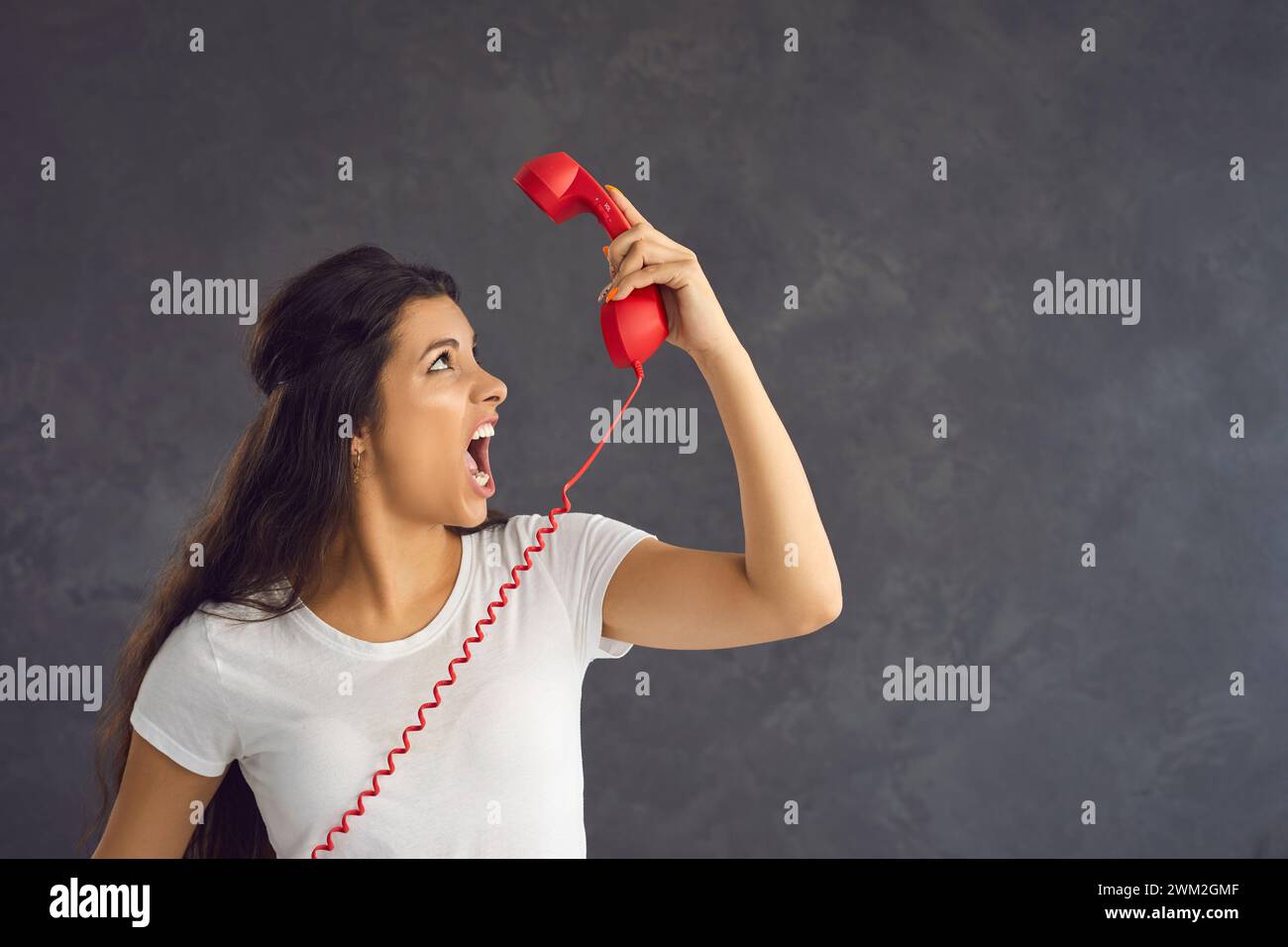 Angry female client irritated and angrily shouting arguing during phone ...