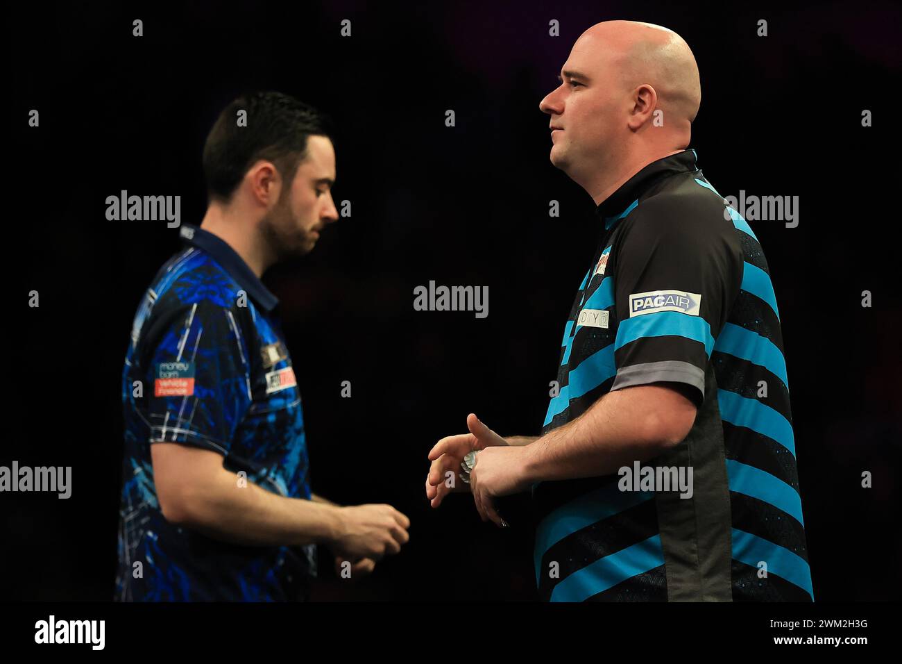 Rob Cross prepares to throw with Luke Humphries in the background ...