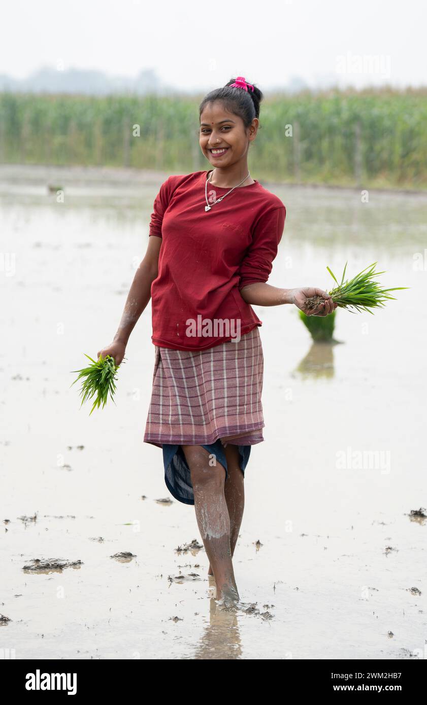 Morigaon, India. 20th Feb, 2024. A women pose for photograph holding ...