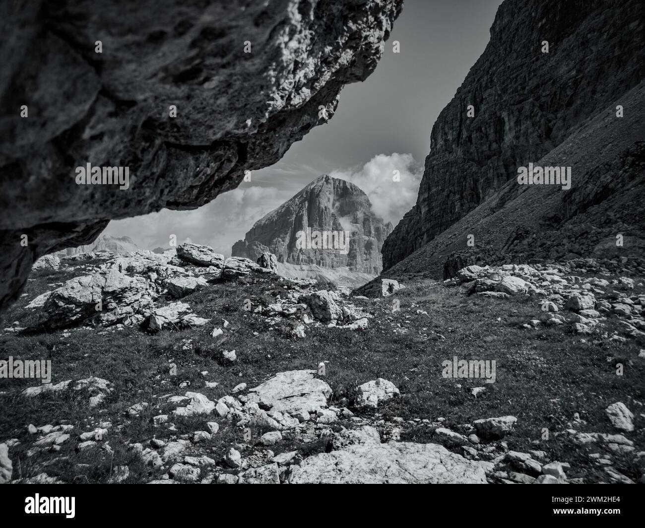 Majestic peak hidden between two mountains in black and white Stock ...
