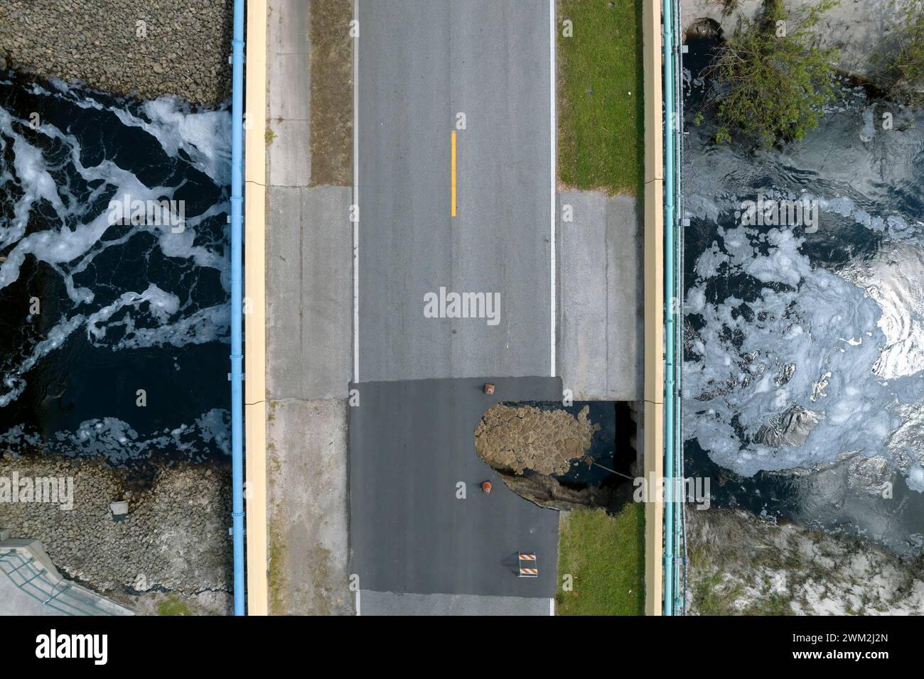 Damaged road bridge destroyed by river after flood water washed away ...