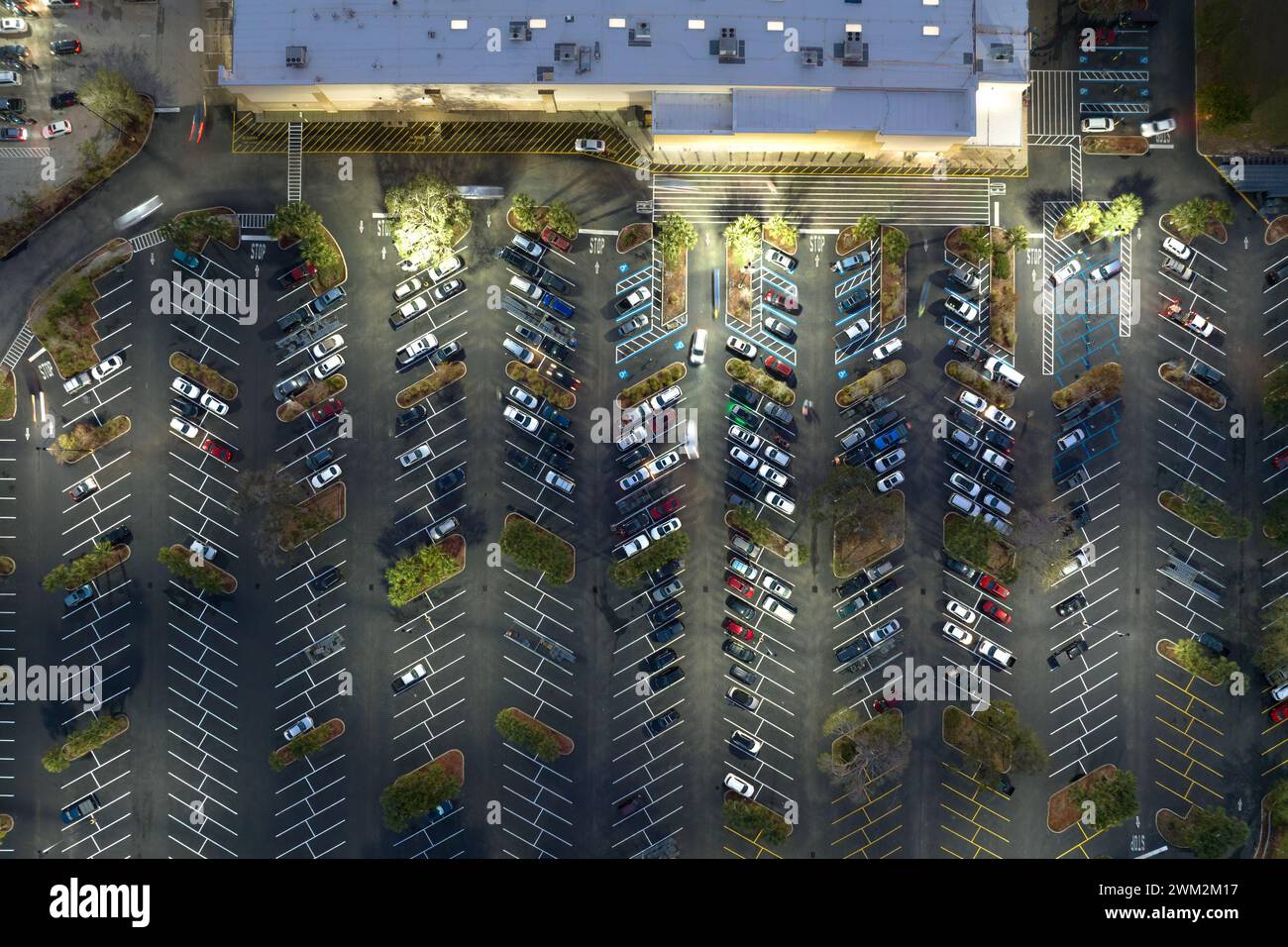 Large parking lot with many parked cars. Big carpark at supercenter ...