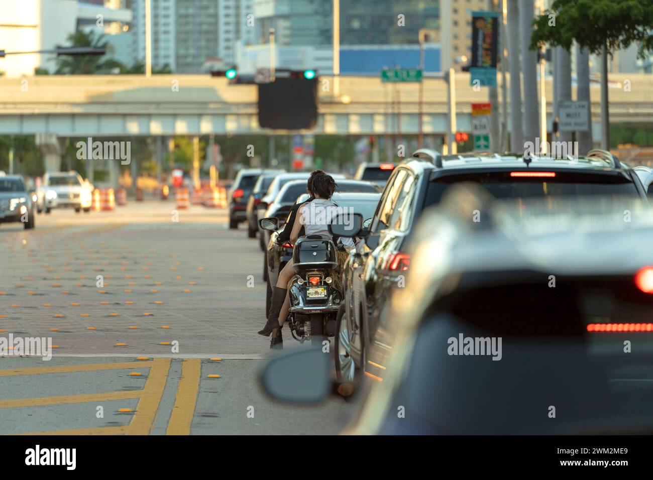 Motorcycle and cars traffic driving at intersection on American street ...