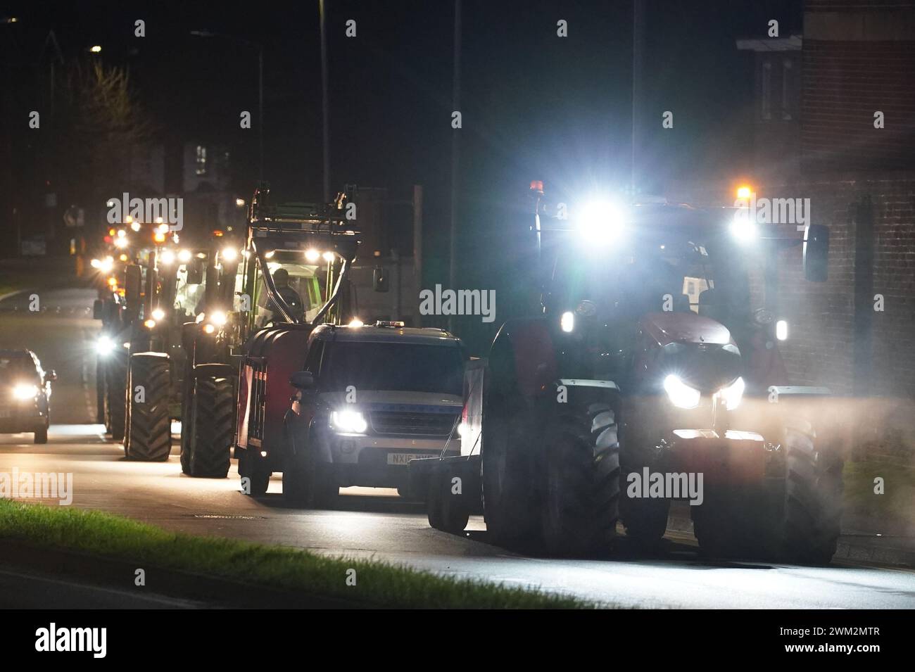 Farmers driving their tractors in a convoy in Ashford, Kent to protest ...