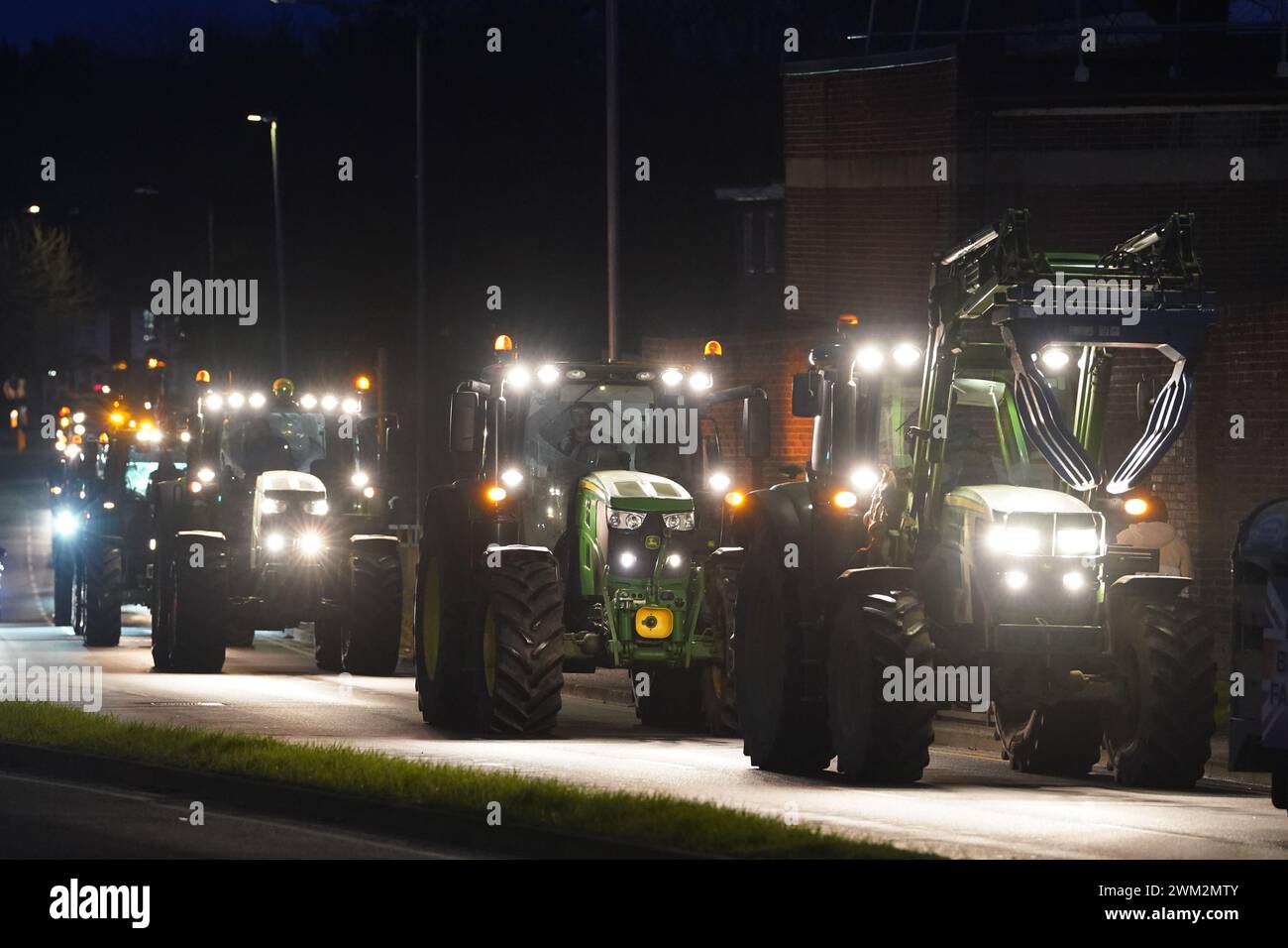 Farmers driving their tractors in a convoy in Ashford, Kent to protest ...