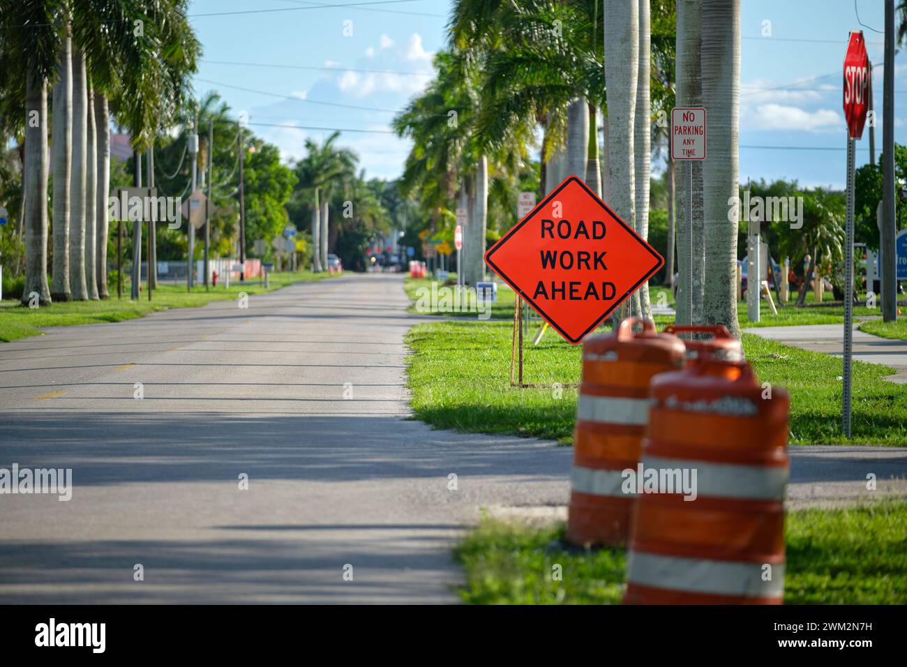 Road work ahead sign and barrier cones on street site as warning to ...