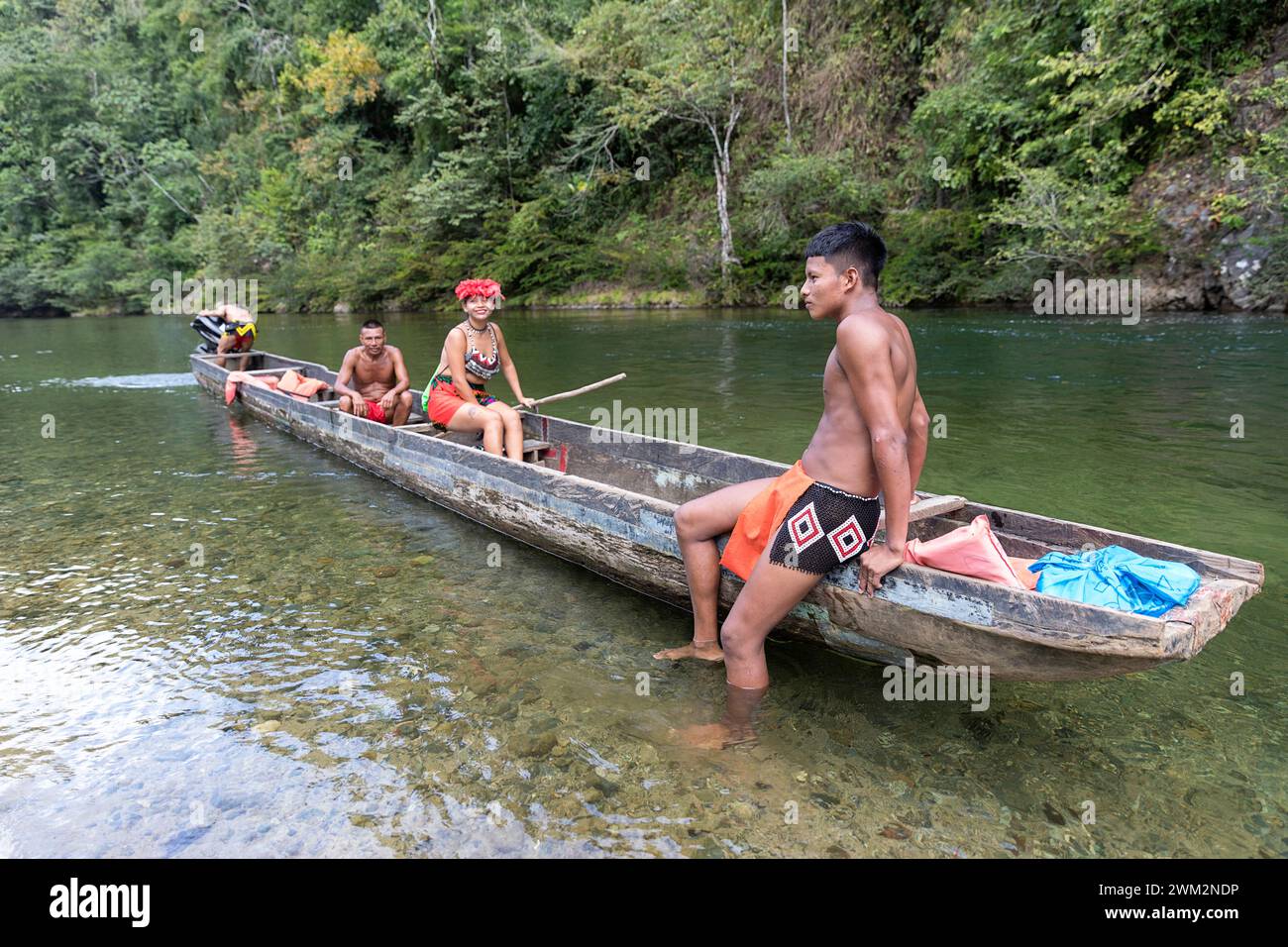 A family from Embera tribe in their traditional clothes sitting in a ...