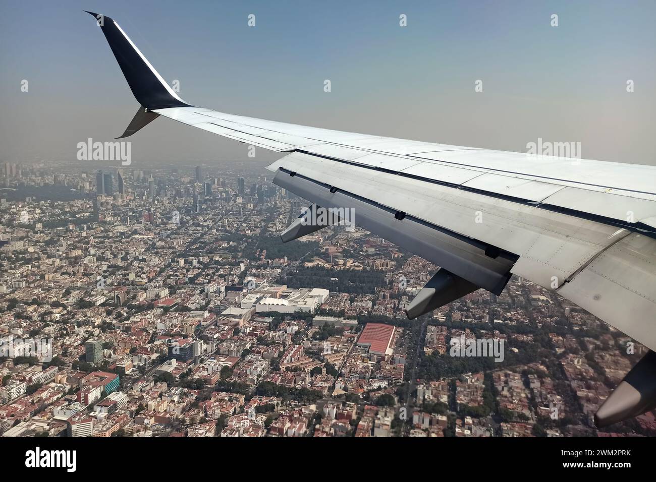 View on Mexico city through airplane window of commercial jet plane ...